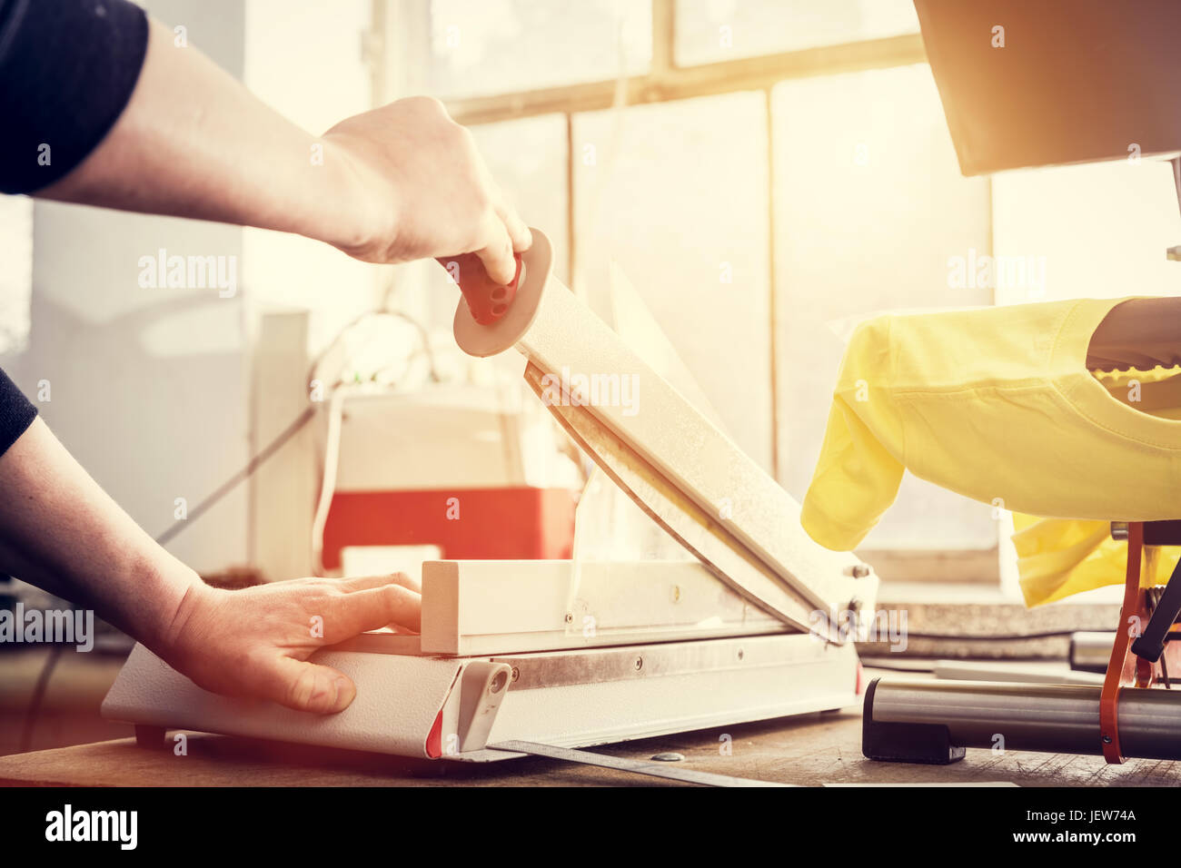 Man using manual paper cutter. Manufacture work Stock Photo - Alamy