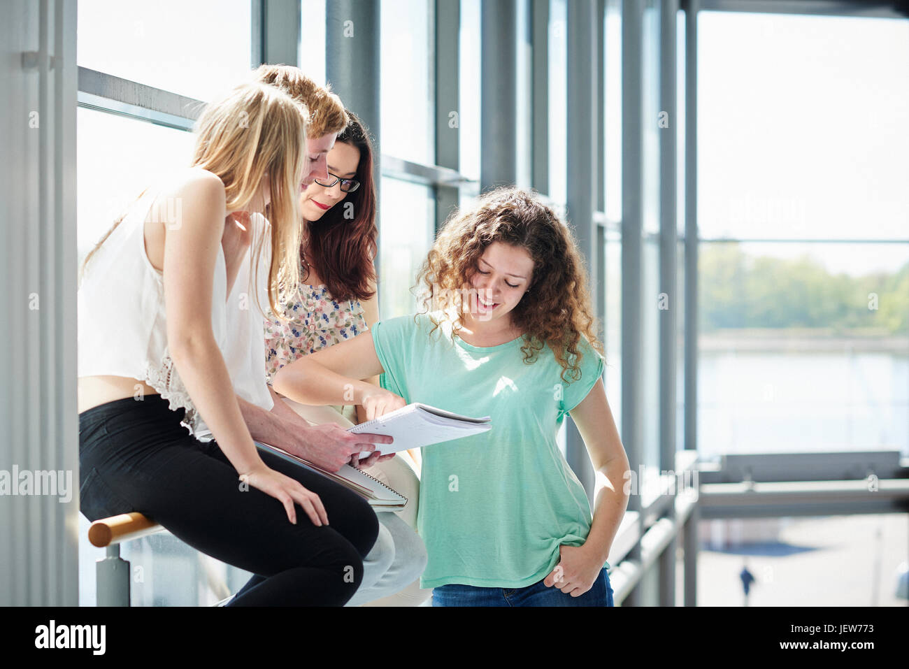 Friends on corridor Stock Photo - Alamy