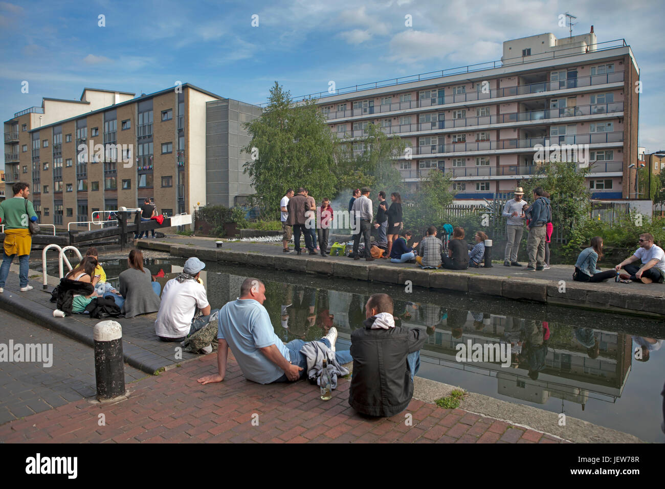 LONDON, ENGLAND - JULY 12, 2017 Unknown young local people sitting ...