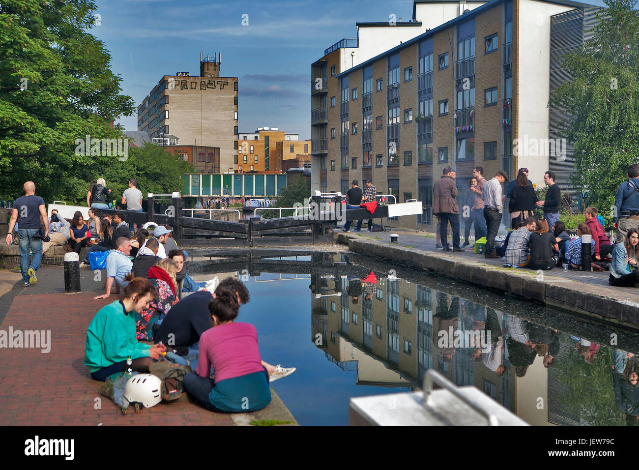 LONDON, ENGLAND - JULY 12, 2017 Unknown young local people sitting ...