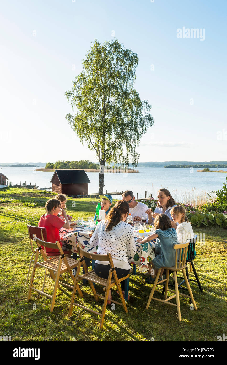 Family having meal at lake Stock Photo - Alamy