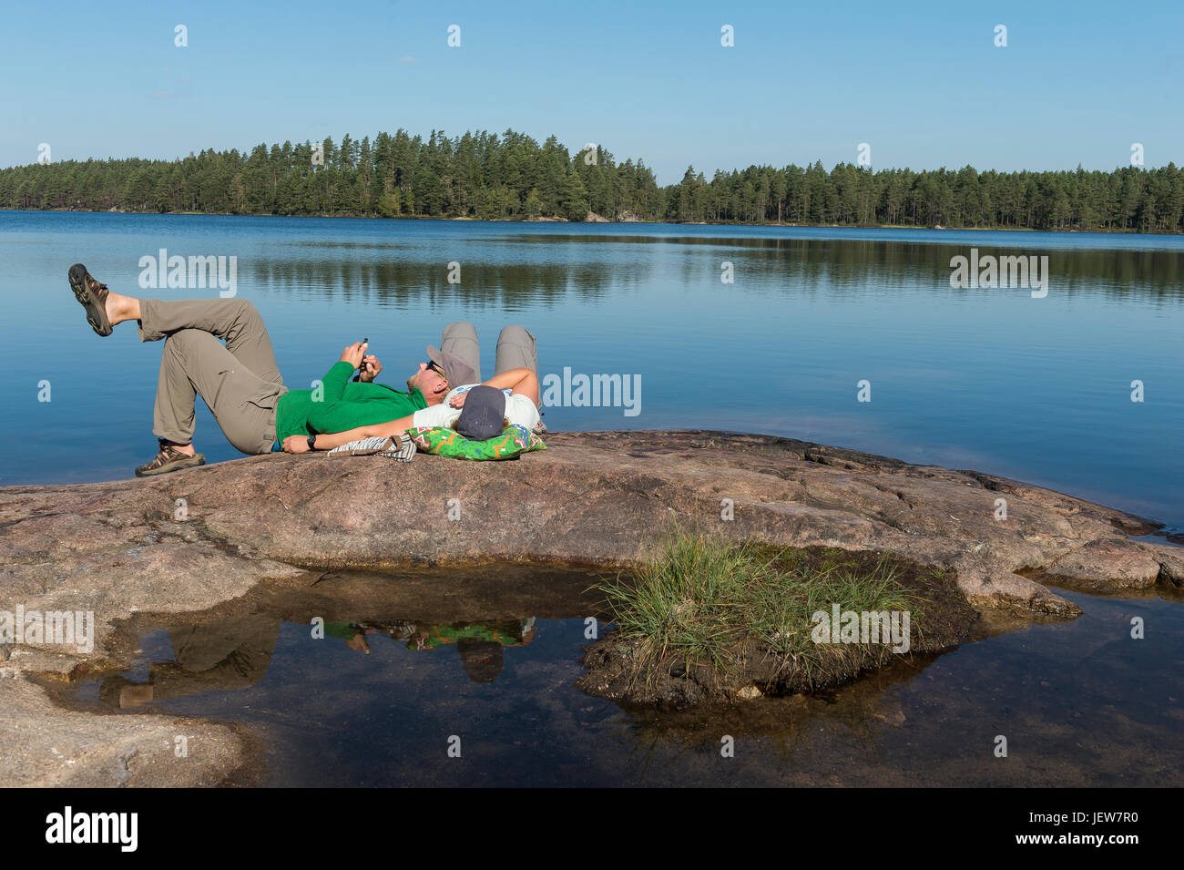 Men relaxing at lake Stock Photo - Alamy