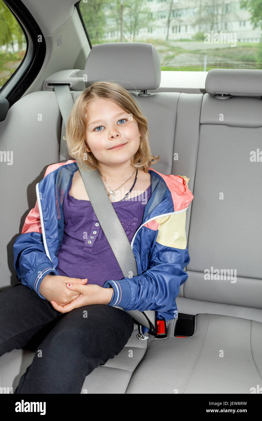 Smiling girl sitting on back seat Stock Photo - Alamy