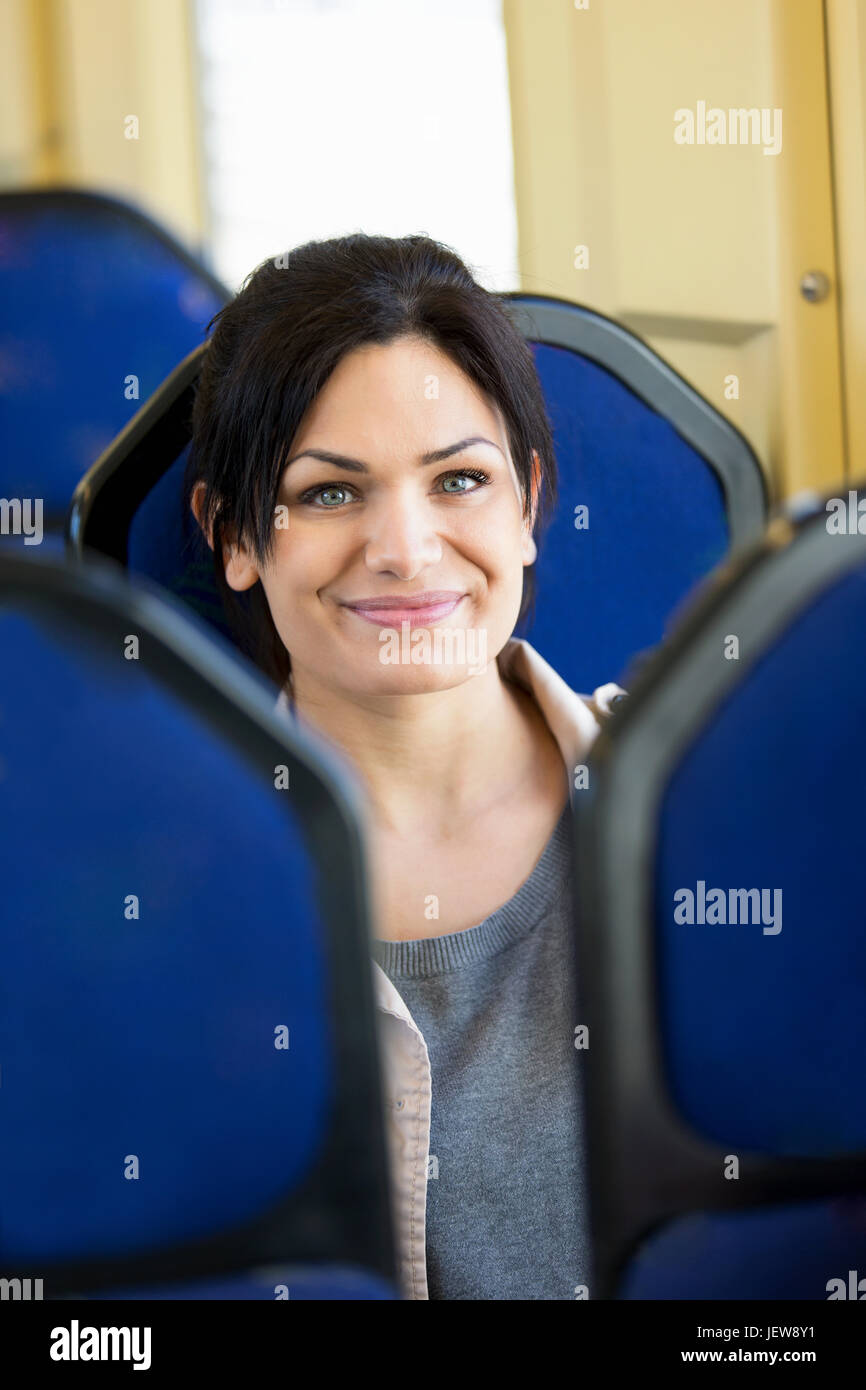Smiling woman in train Stock Photo - Alamy