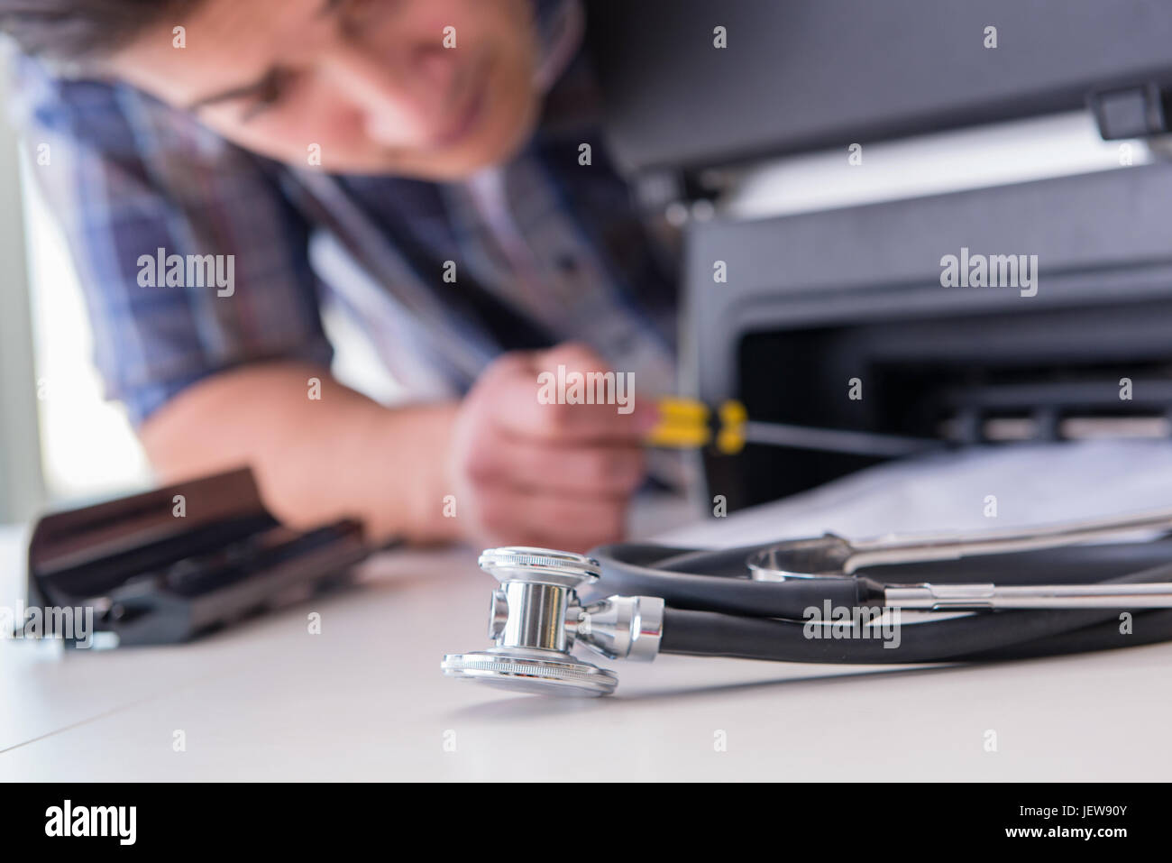 Repairman repairing broken color printer Stock Photo - Alamy