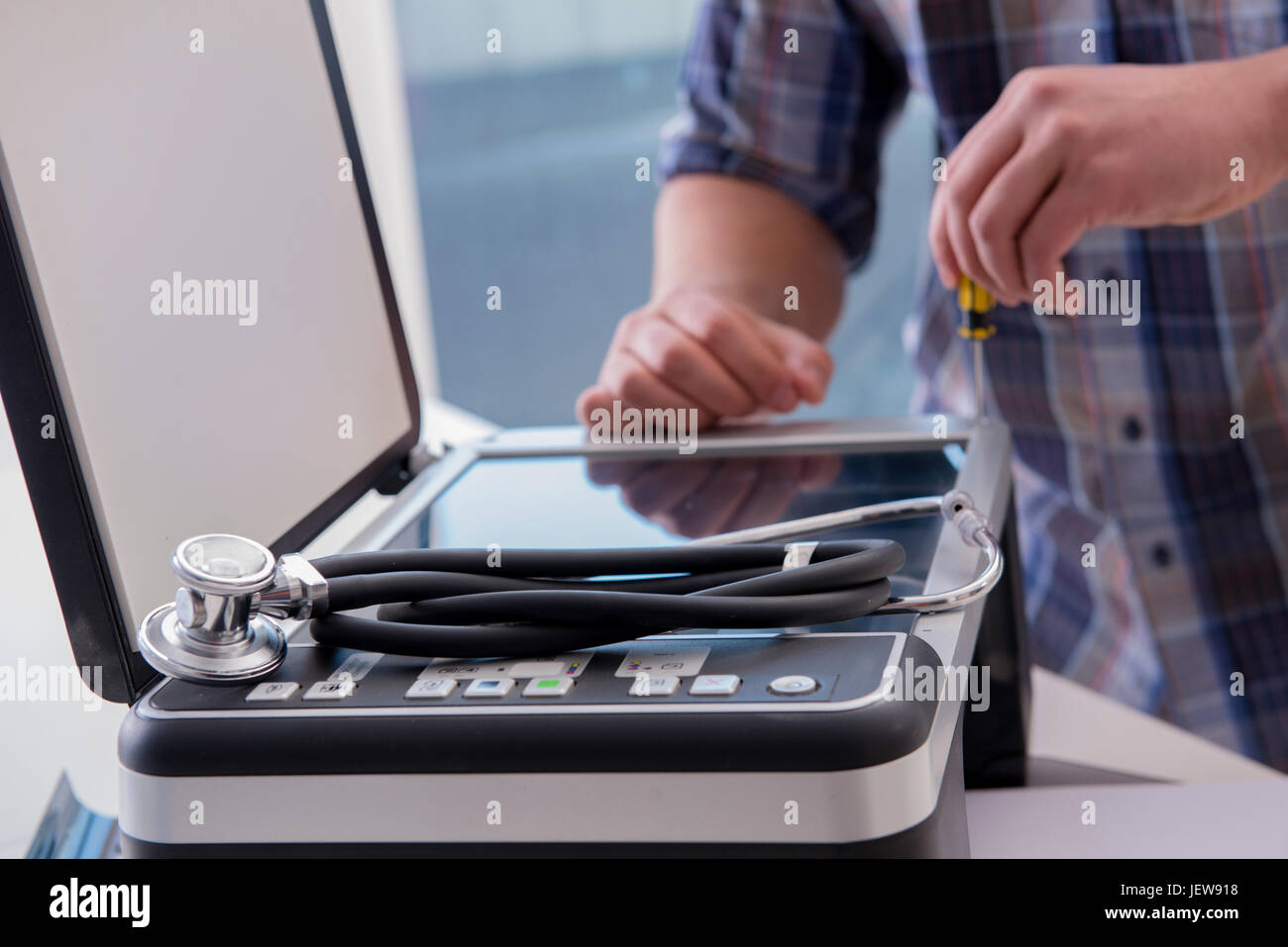 Repairman repairing broken color printer Stock Photo - Alamy