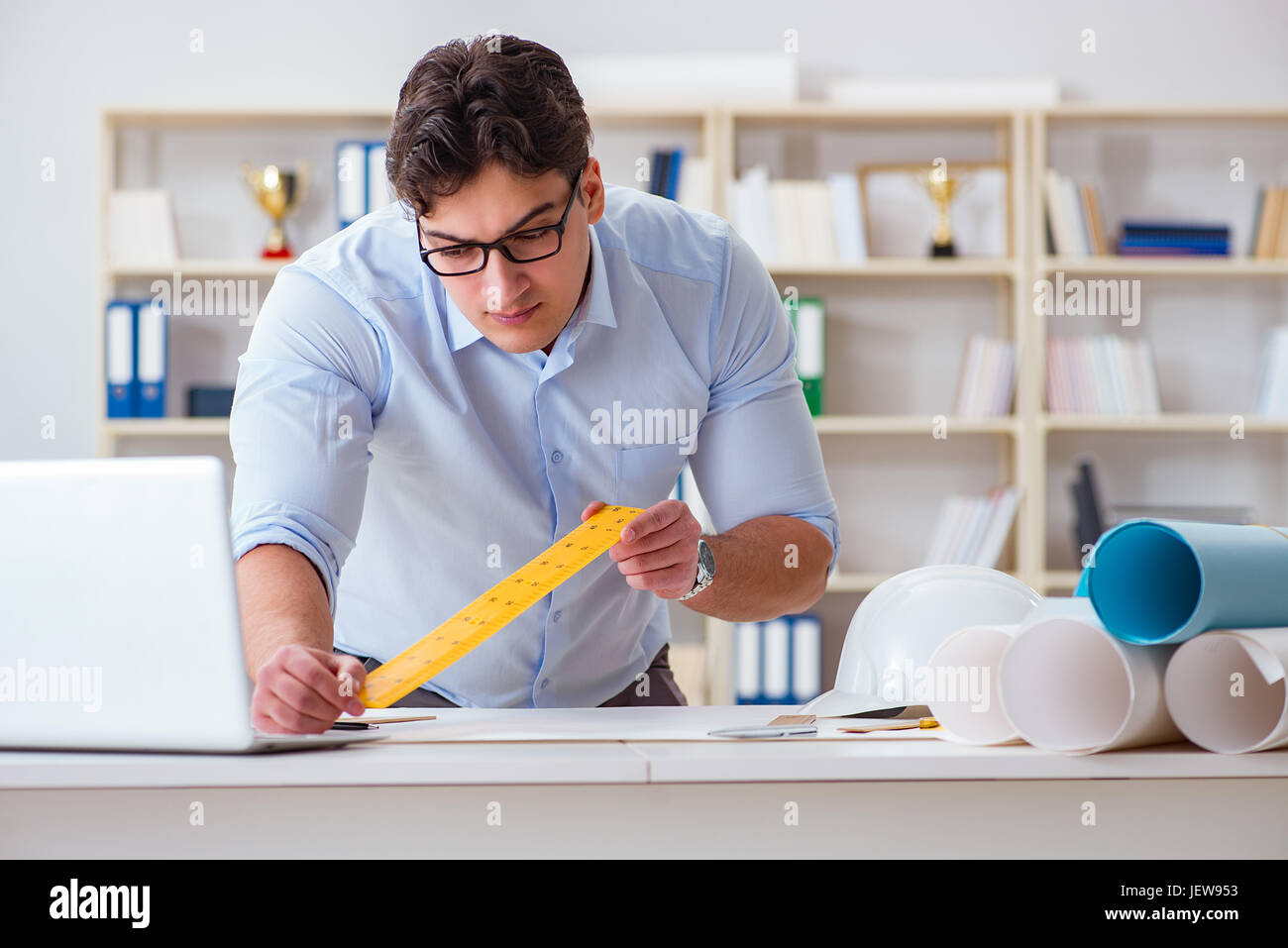 Male engineer working on drawings and blueprints Stock Photo - Alamy