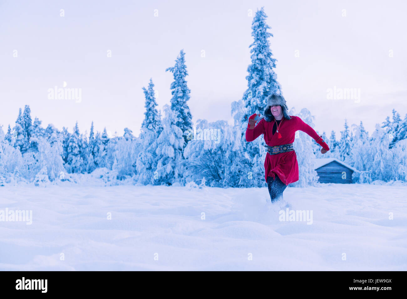 Woman running through snow Stock Photo - Alamy
