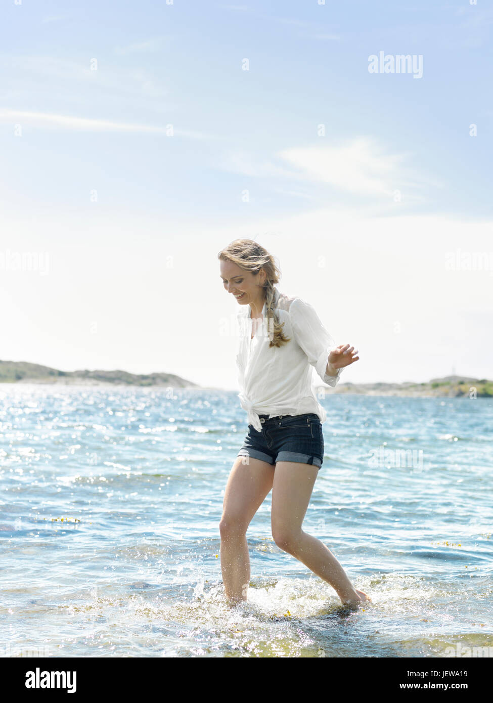 Woman running in sea Stock Photo - Alamy