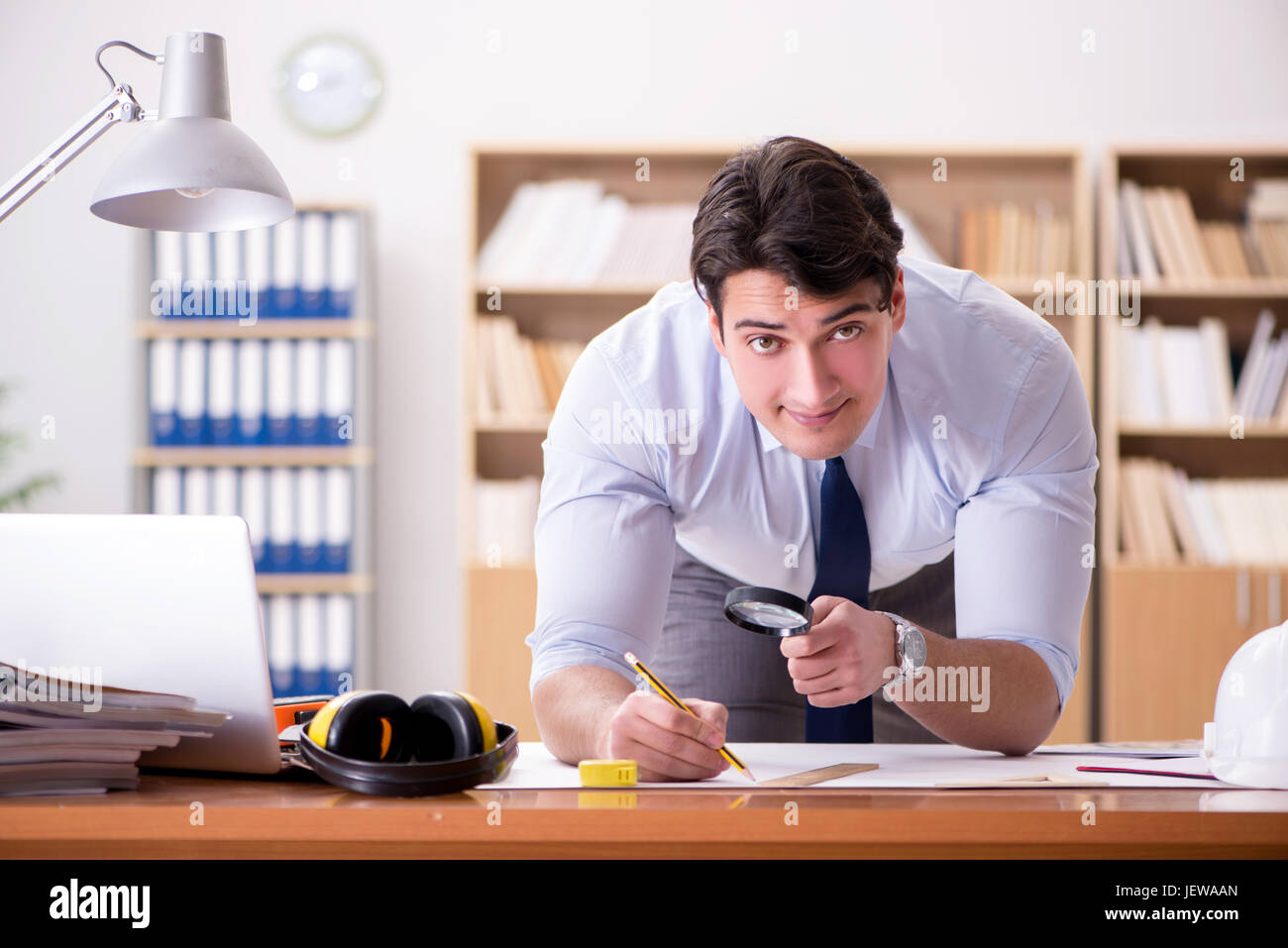 Engineer supervisor working on drawings in the office Stock Photo - Alamy