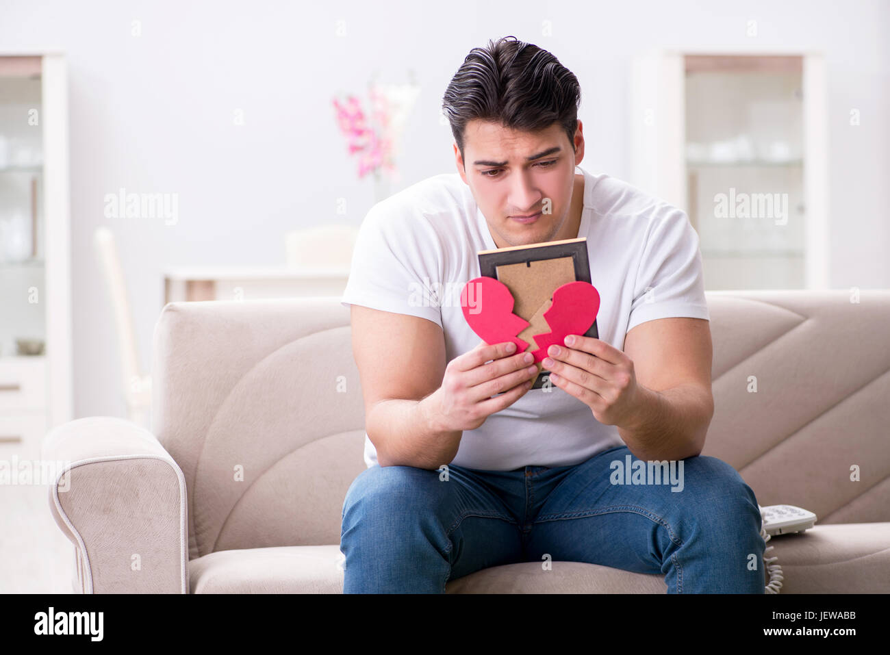 Young man in sad saint valentine concept Stock Photo - Alamy