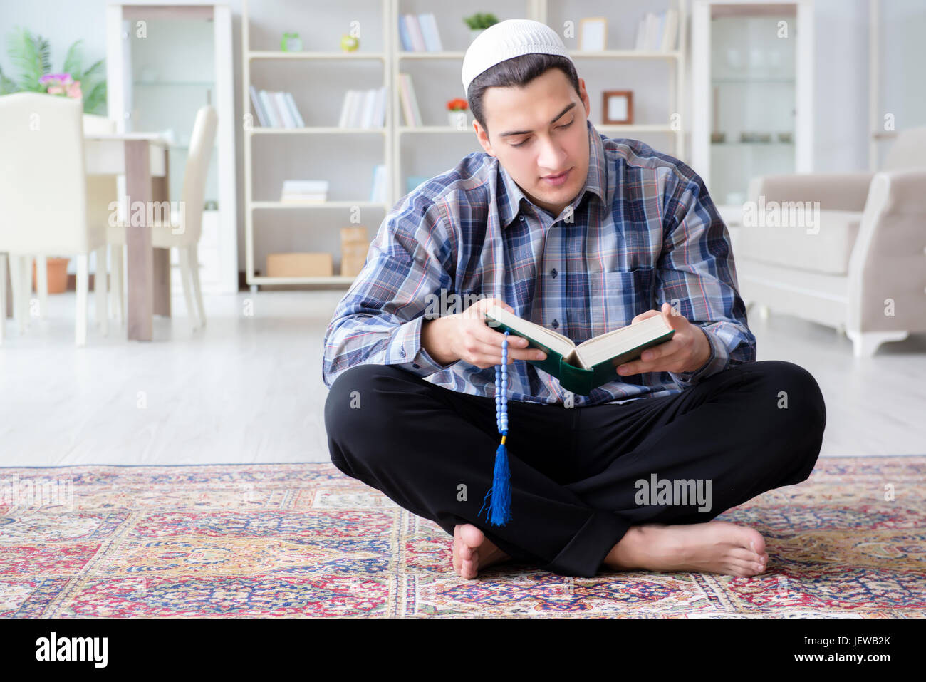 Muslim man praying at home Stock Photo - Alamy