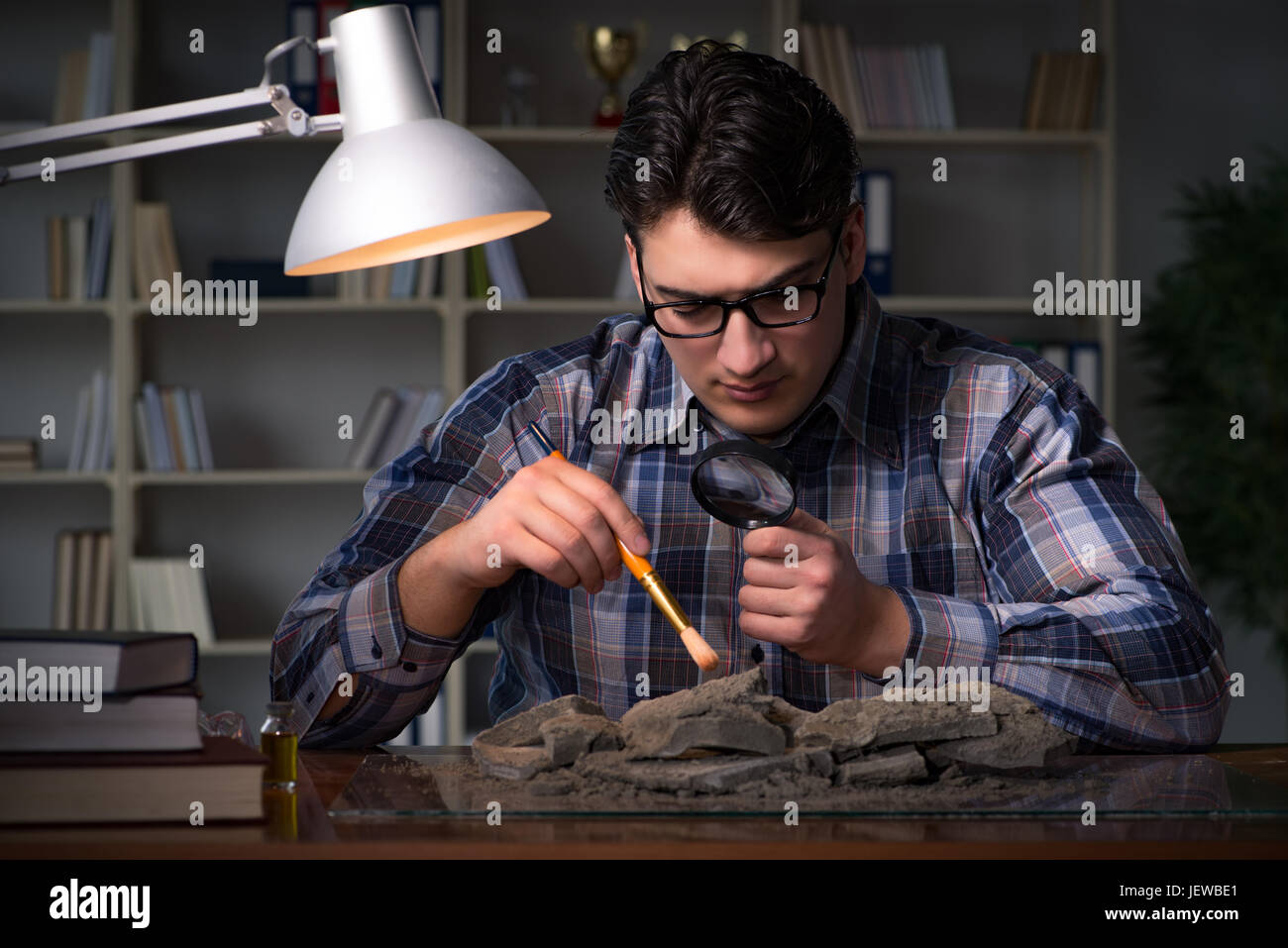 Archeologist working late night in office Stock Photo - Alamy