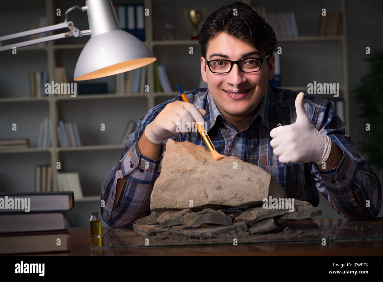 Archeologist working late night in office Stock Photo - Alamy
