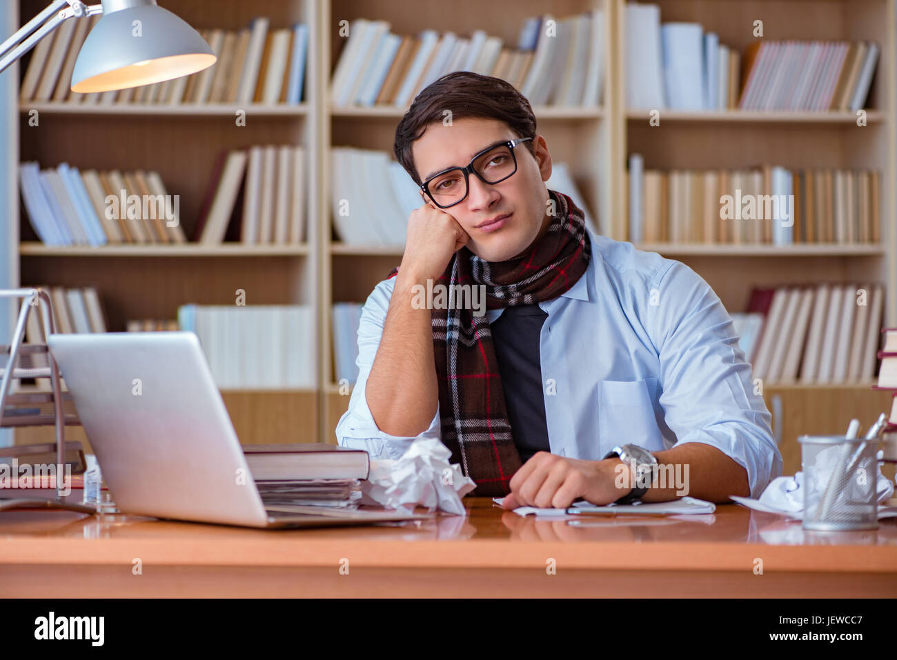 Young book writer writing in library Stock Photo - Alamy