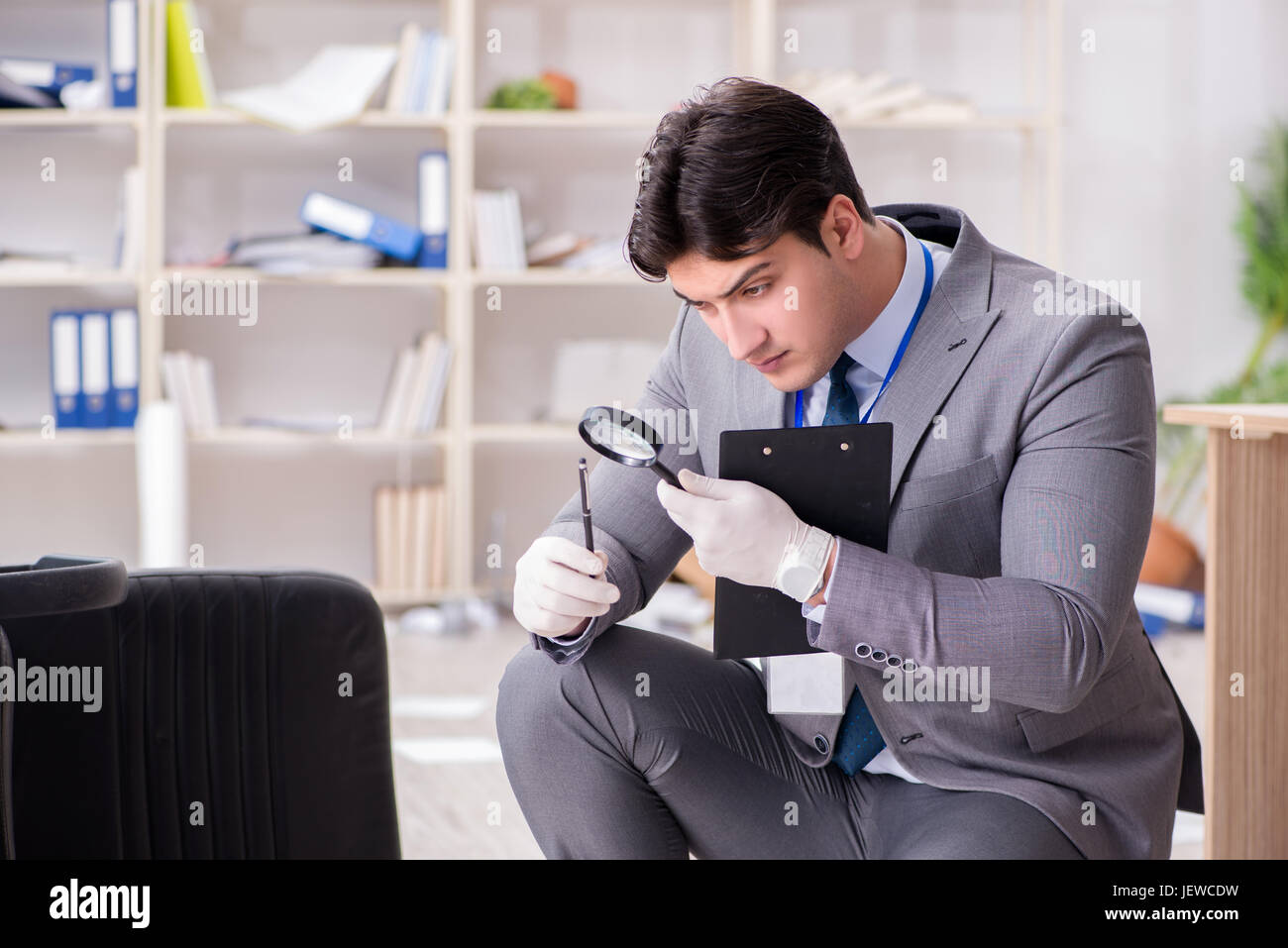 Young man during crime investigation in office Stock Photo - Alamy
