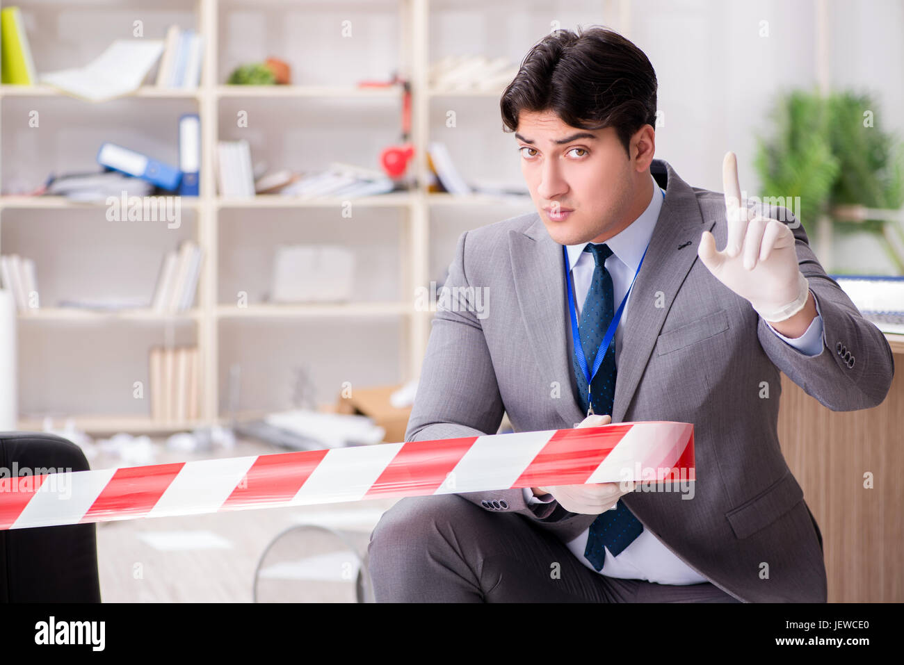 Young man during crime investigation in office Stock Photo - Alamy