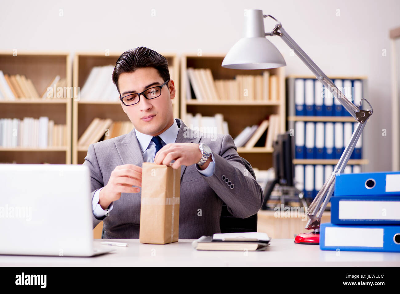 Businessman opening package in office hi-res stock photography and ...