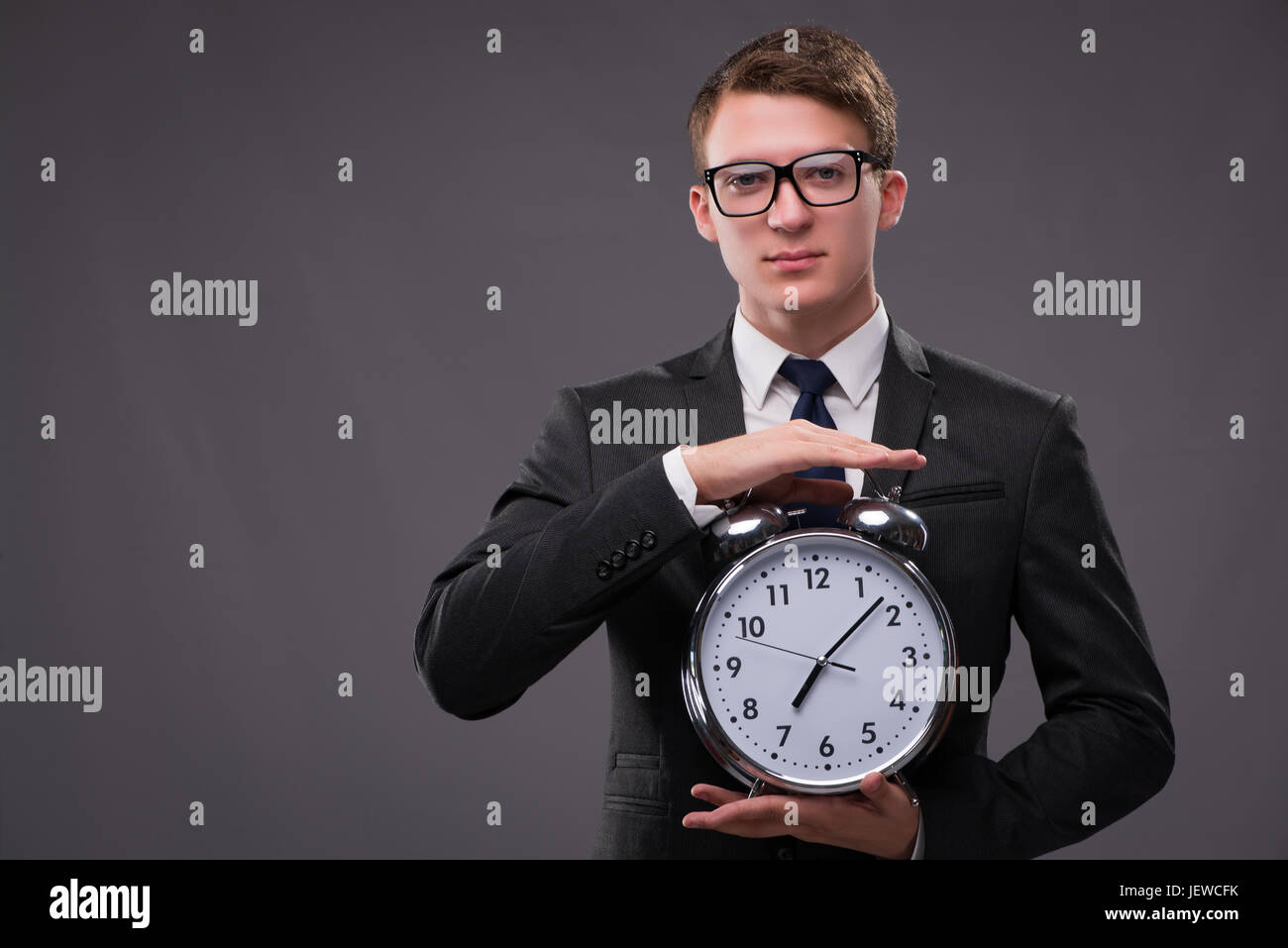 Businessman in time management concept Stock Photo - Alamy