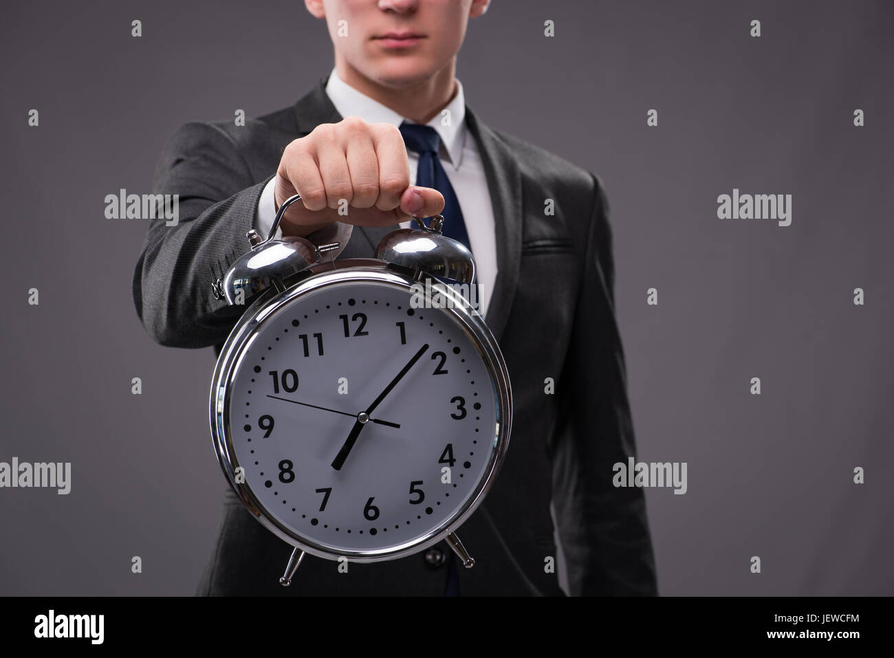 Businessman in time management concept Stock Photo - Alamy
