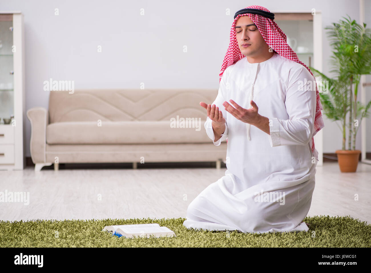 Arab man praying at home Stock Photo - Alamy