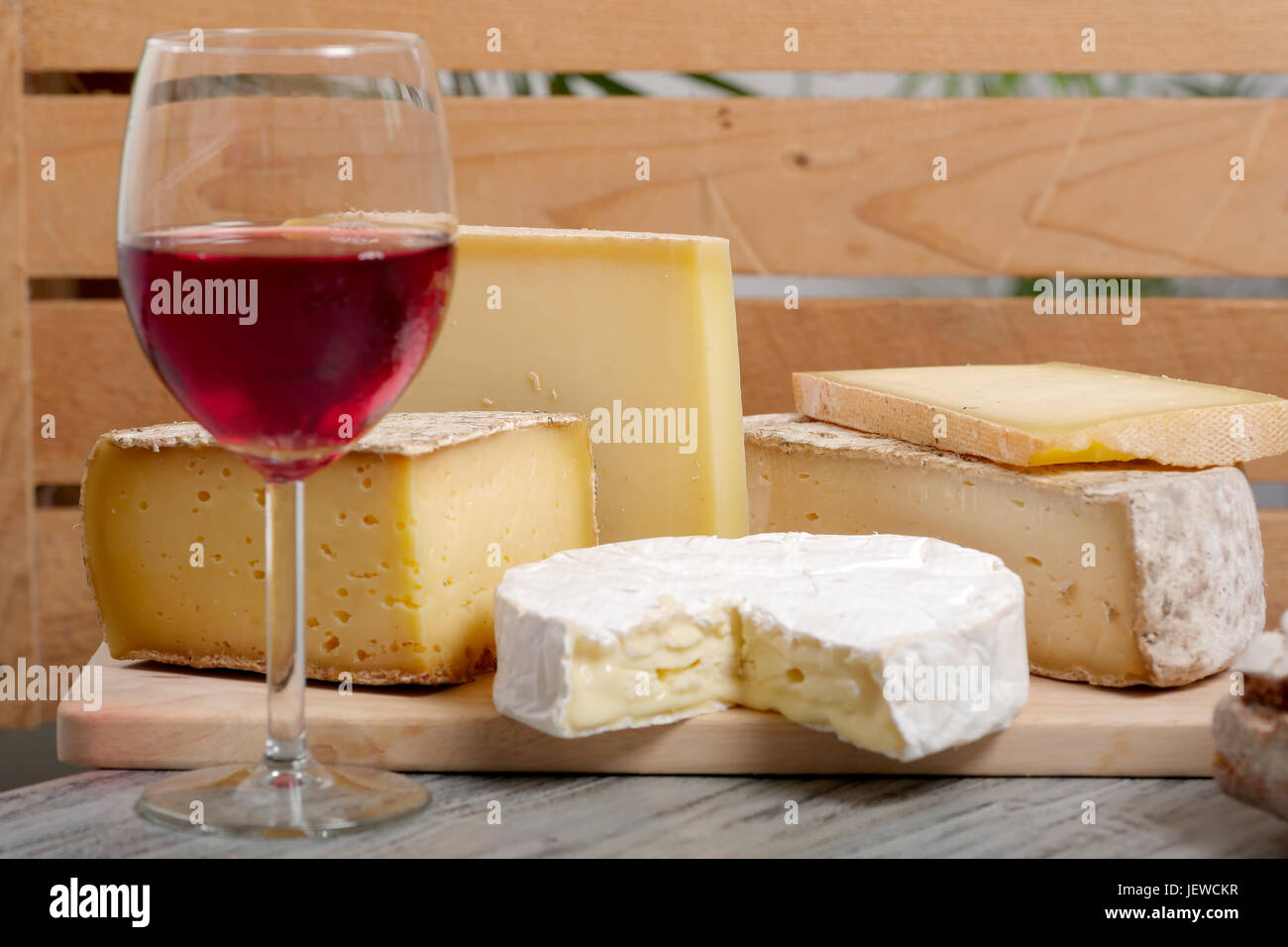 Different french cheeses with a glass of red wine Stock Photo - Alamy
