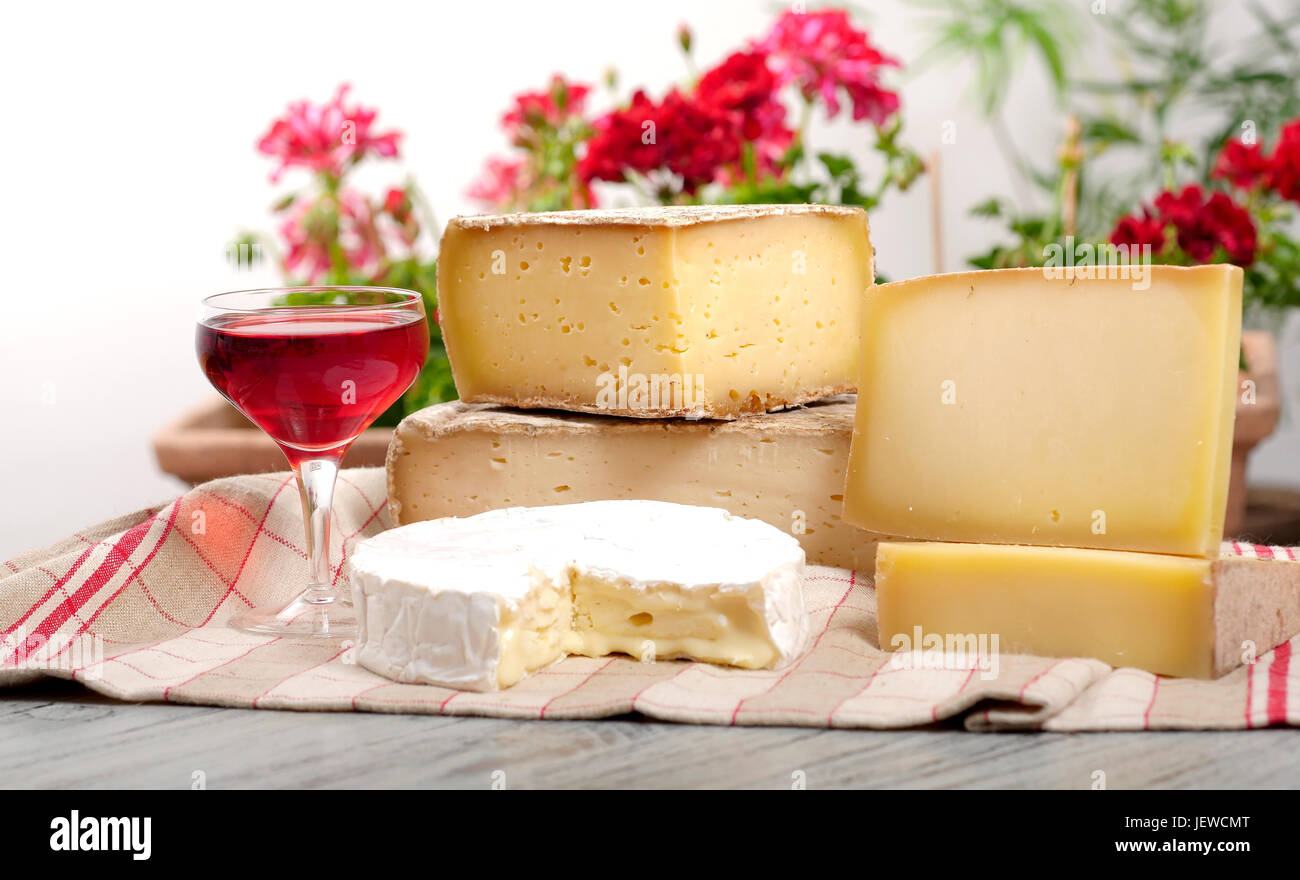 Different french cheeses with a glass of red wine Stock Photo - Alamy