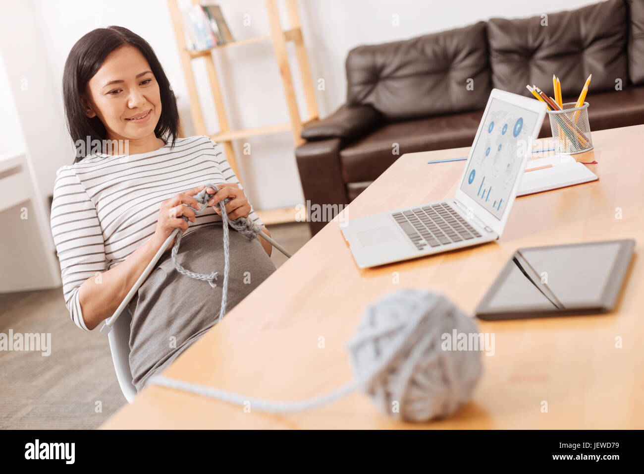 Nice asian woman knitting in the office Stock Photo - Alamy