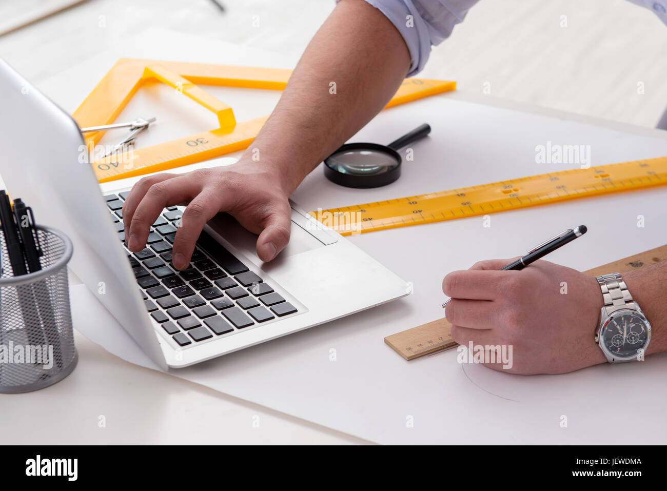 Male engineer working on drawings and blueprints Stock Photo - Alamy