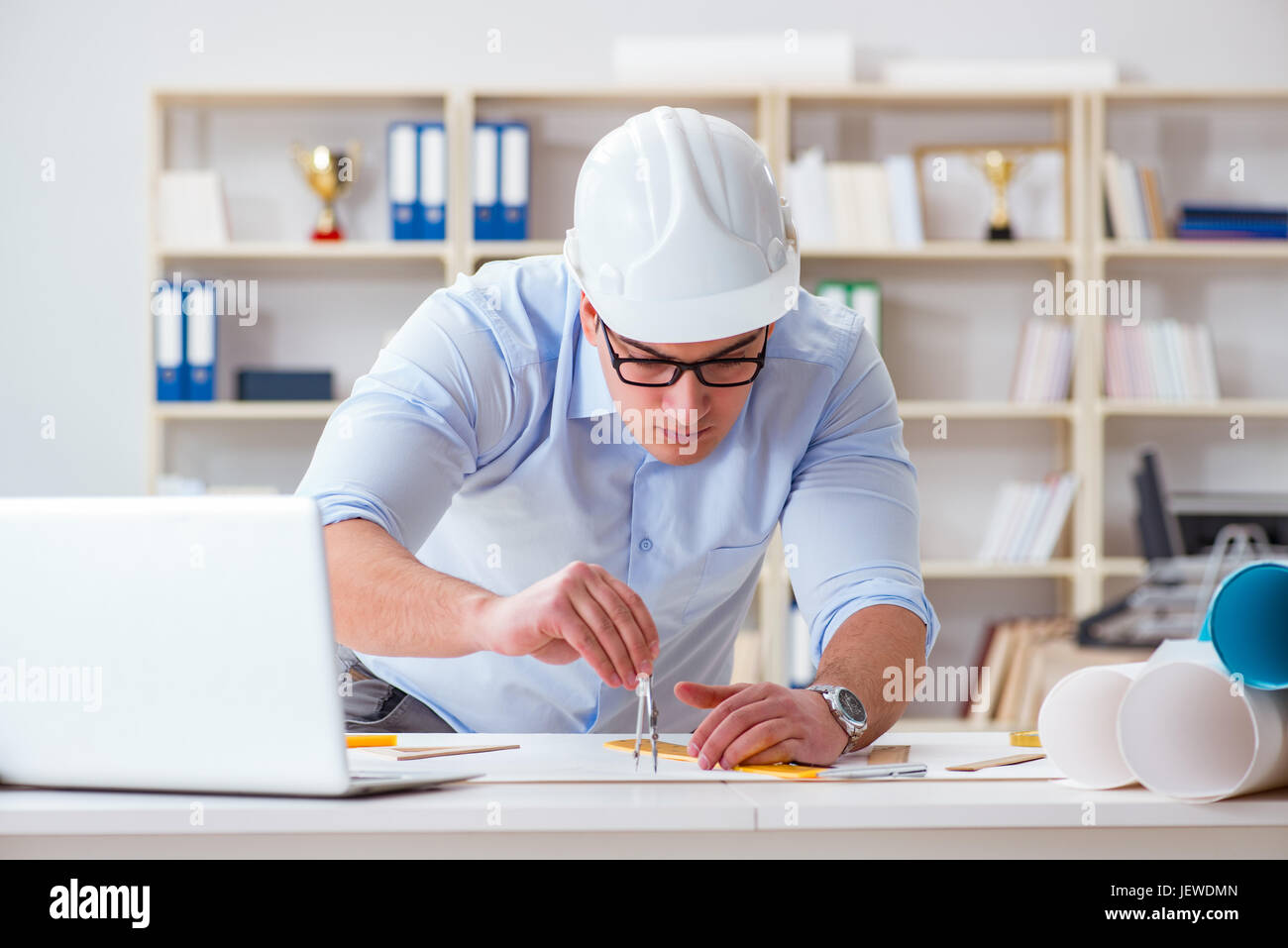 Male engineer working on drawings and blueprints Stock Photo - Alamy