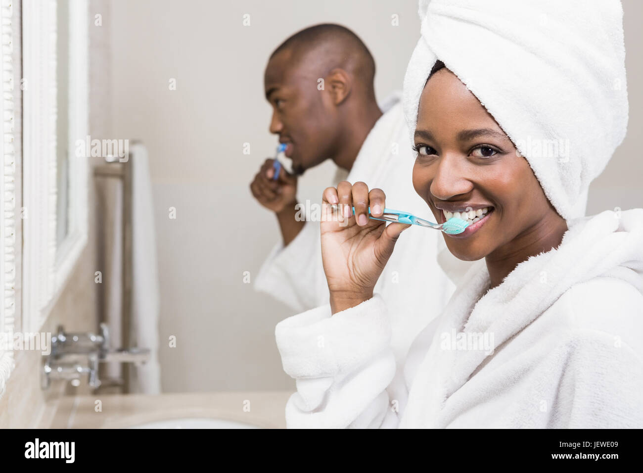 Young couple brushing teeth Stock Photo - Alamy