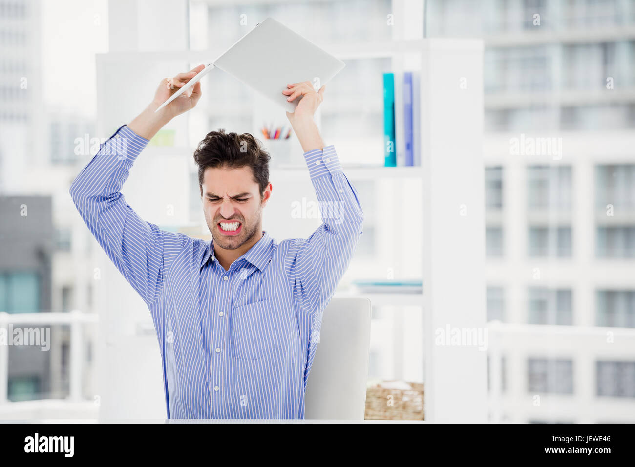 Frustrated businessman throwing laptop Stock Photo - Alamy