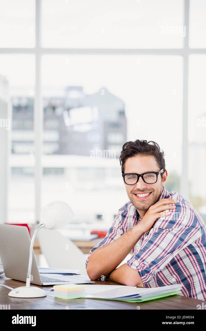 Young man sitting at his desk Stock Photo - Alamy