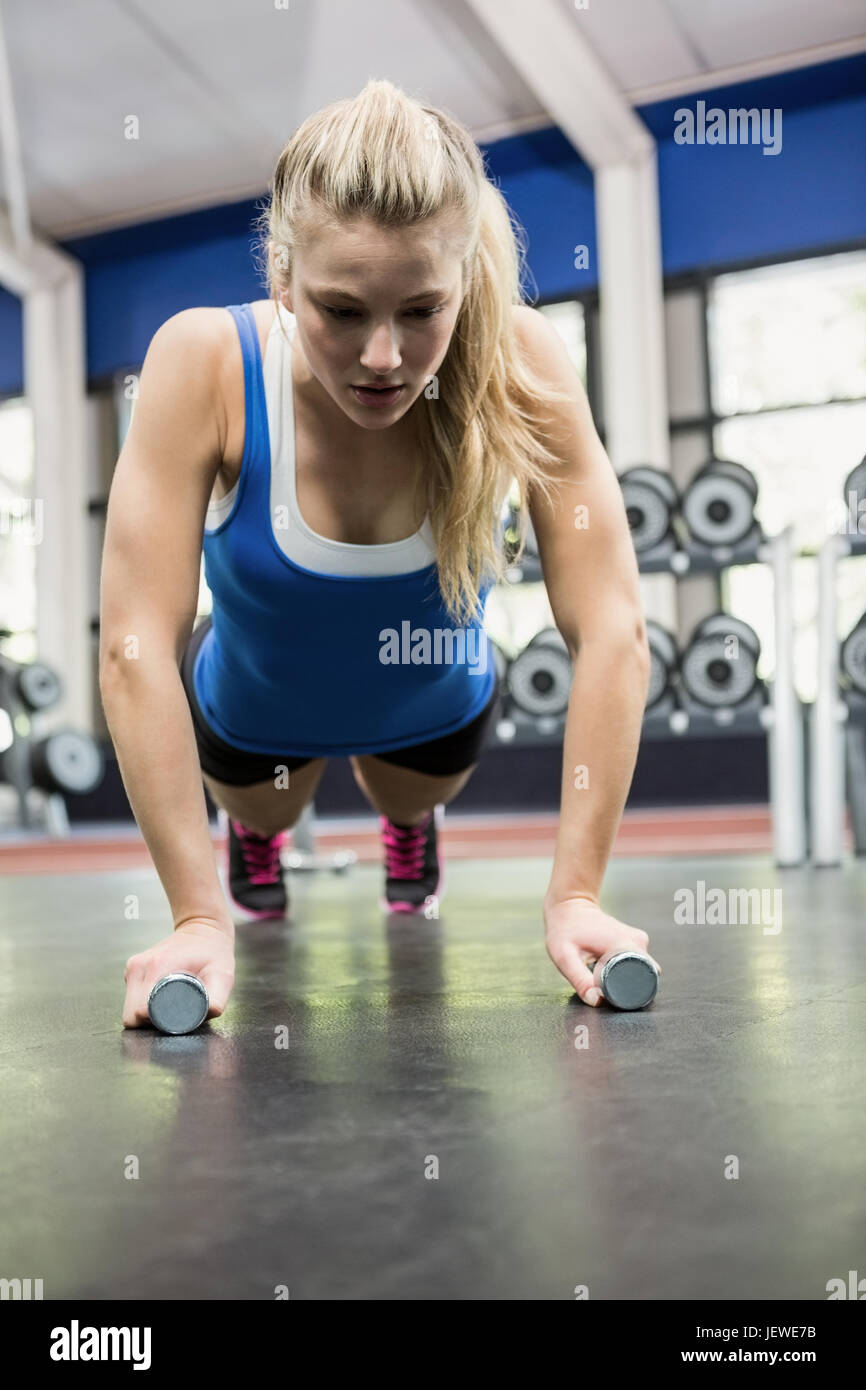 Determined woman doing push ups Stock Photo - Alamy