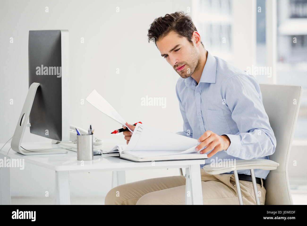 Businessman taking notes at his desk Stock Photo - Alamy