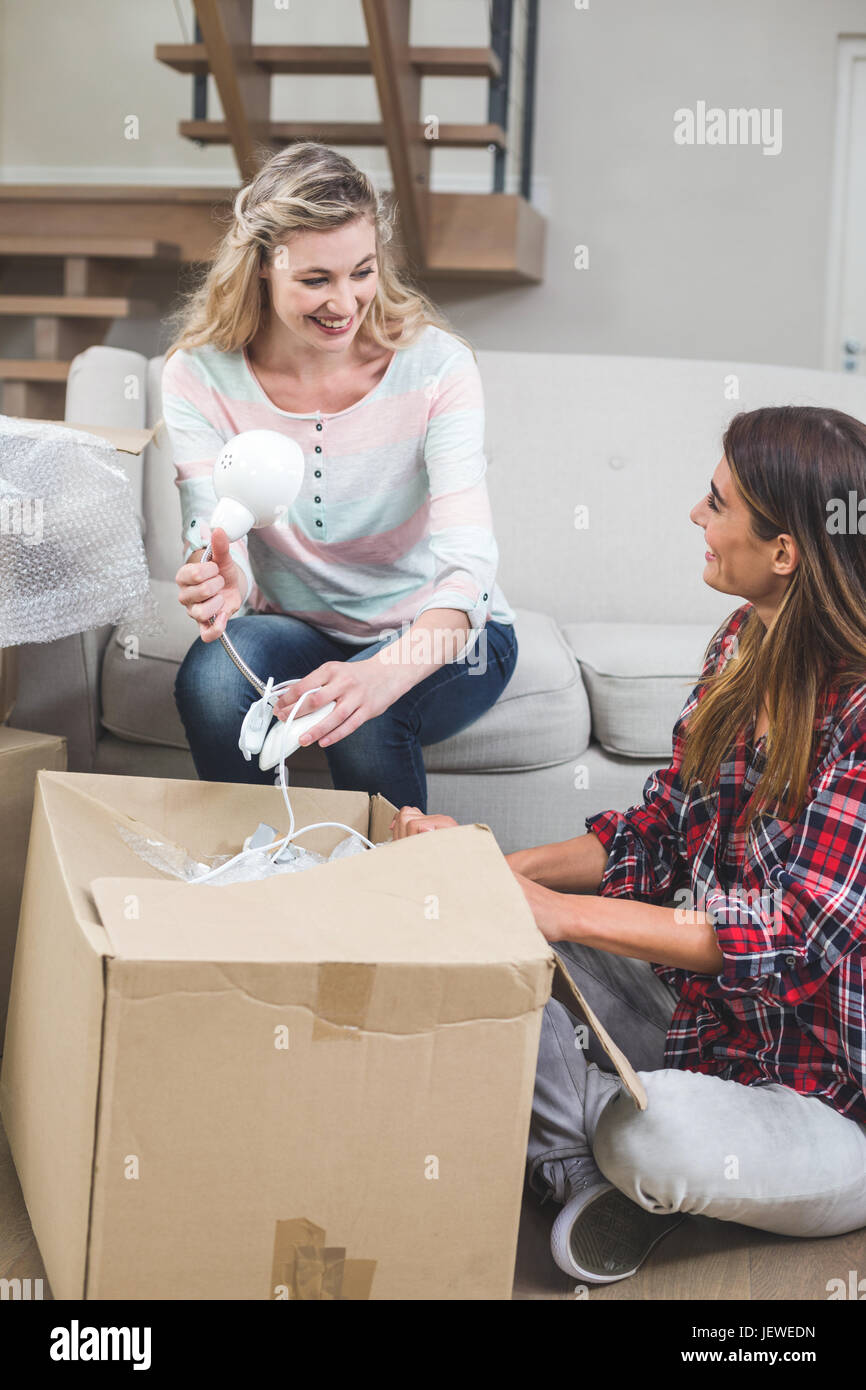 Friends unpacking carton boxes Stock Photo - Alamy
