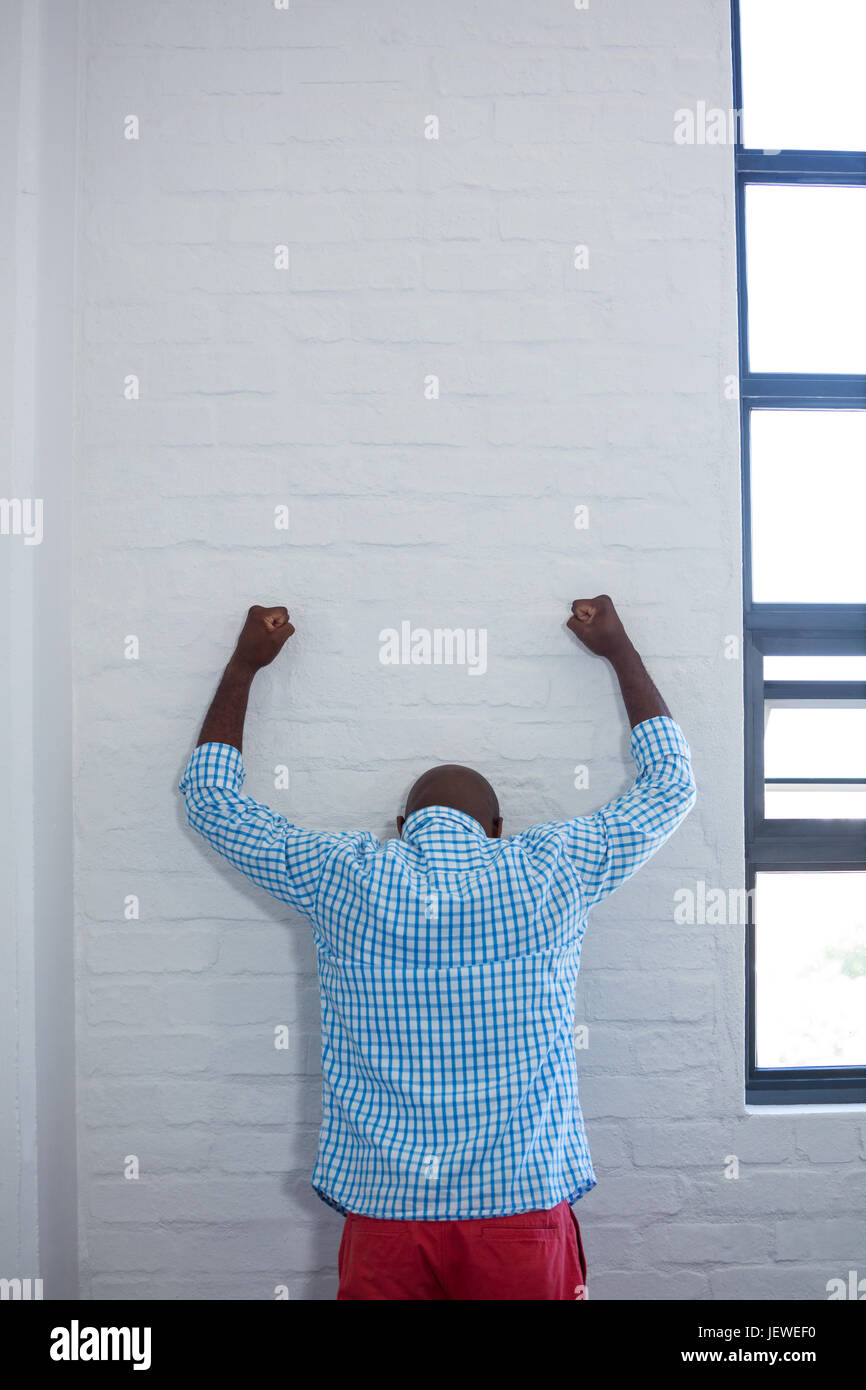 Upset man leaning against wall hi-res stock photography and images - Alamy