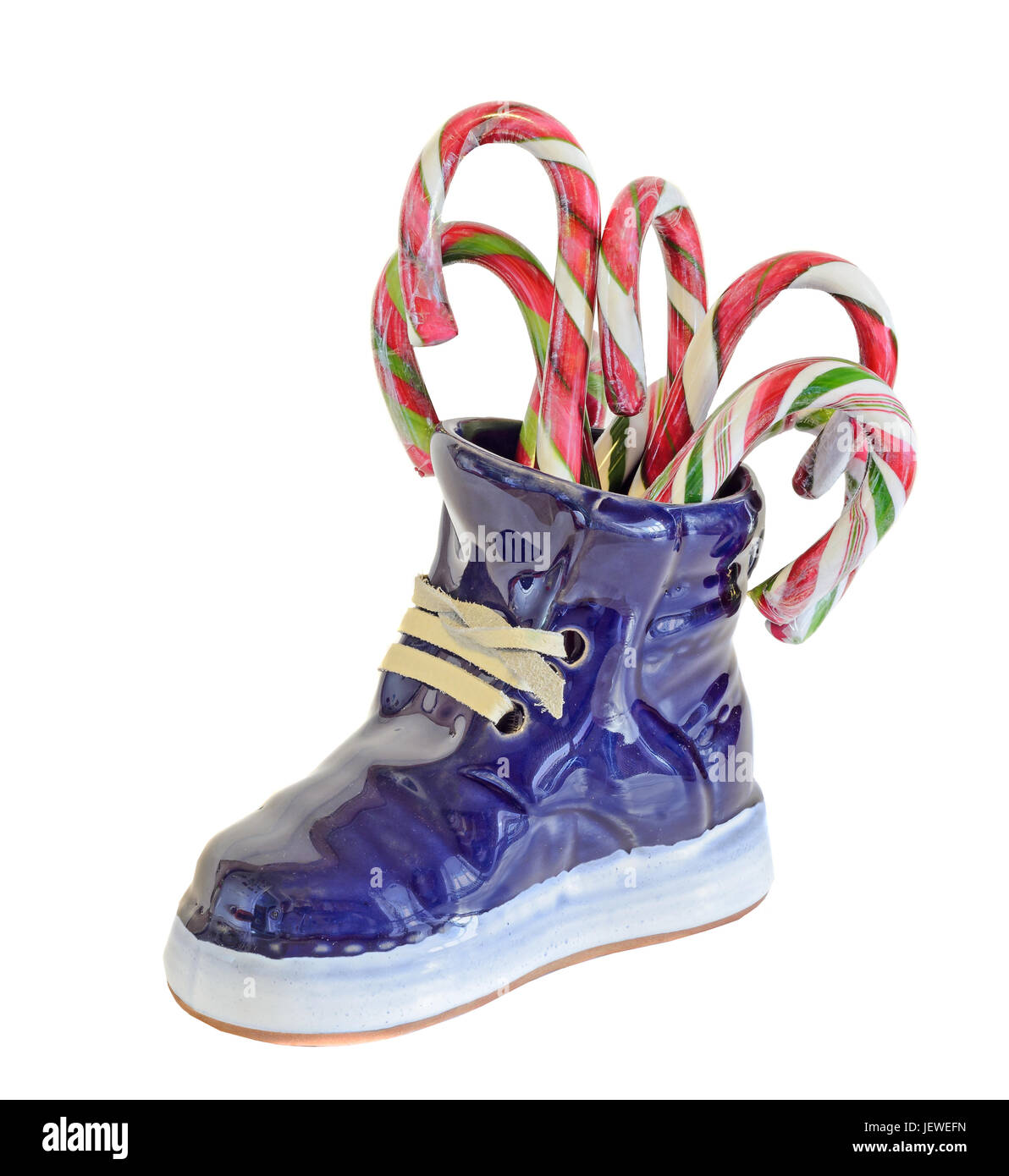 Blue ceramic boots with candies, lollipops, sneakers, close up ...