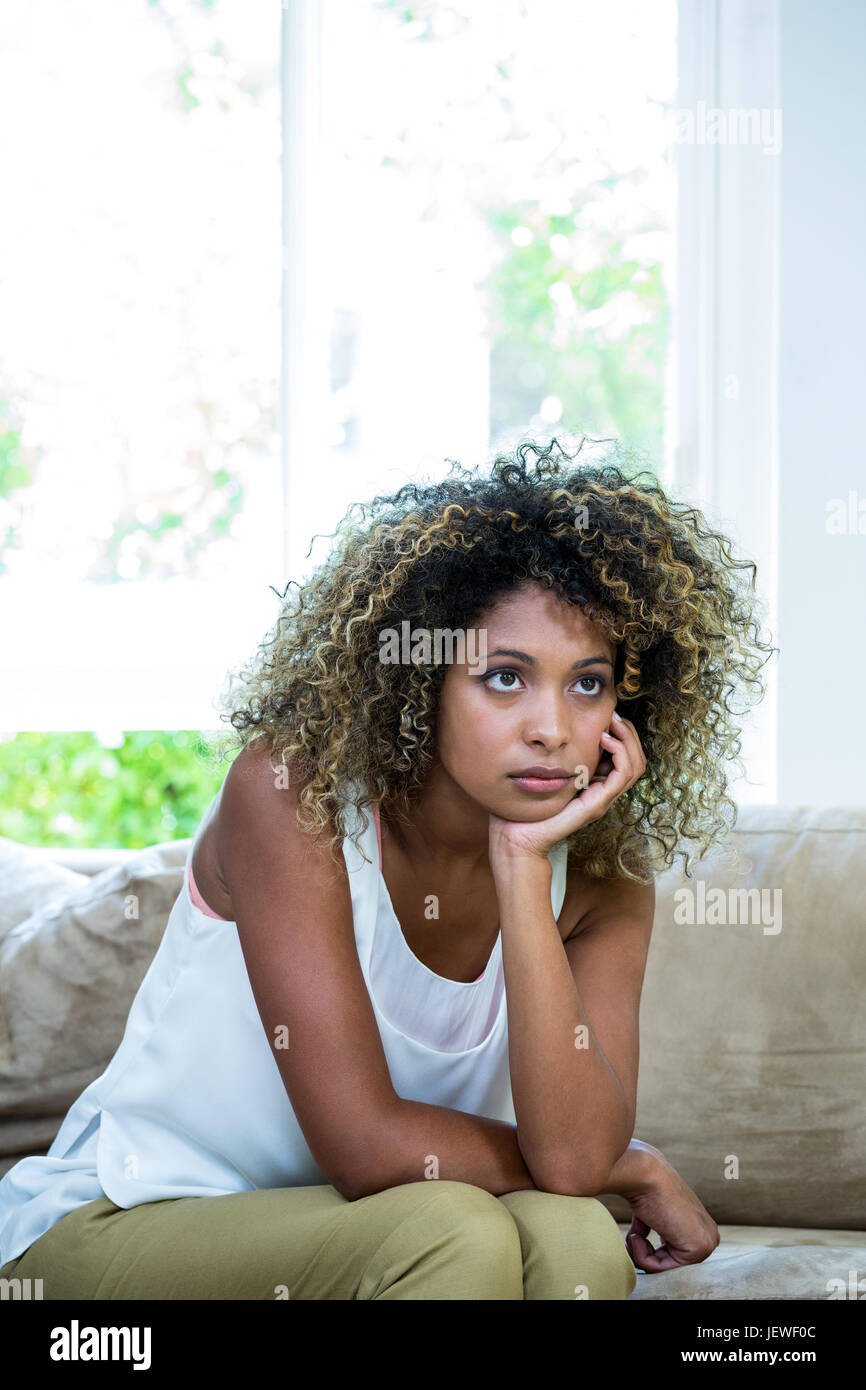 Tensed woman sitting on bed hi-res stock photography and images - Alamy