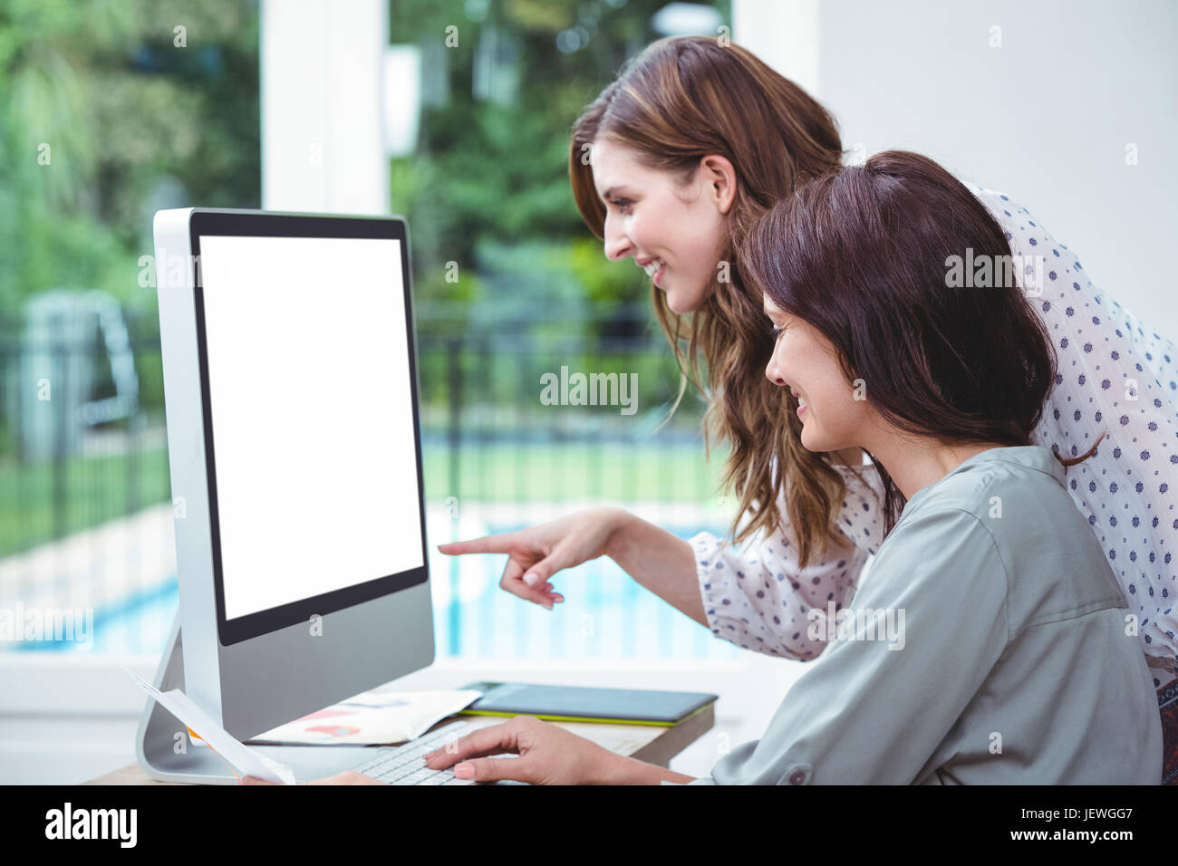 Two beautiful woman using computer Stock Photo - Alamy