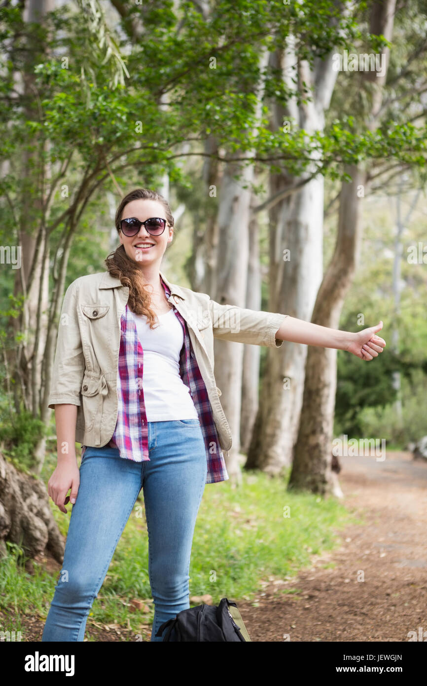 Portrait of woman hitch hiking Stock Photo - Alamy