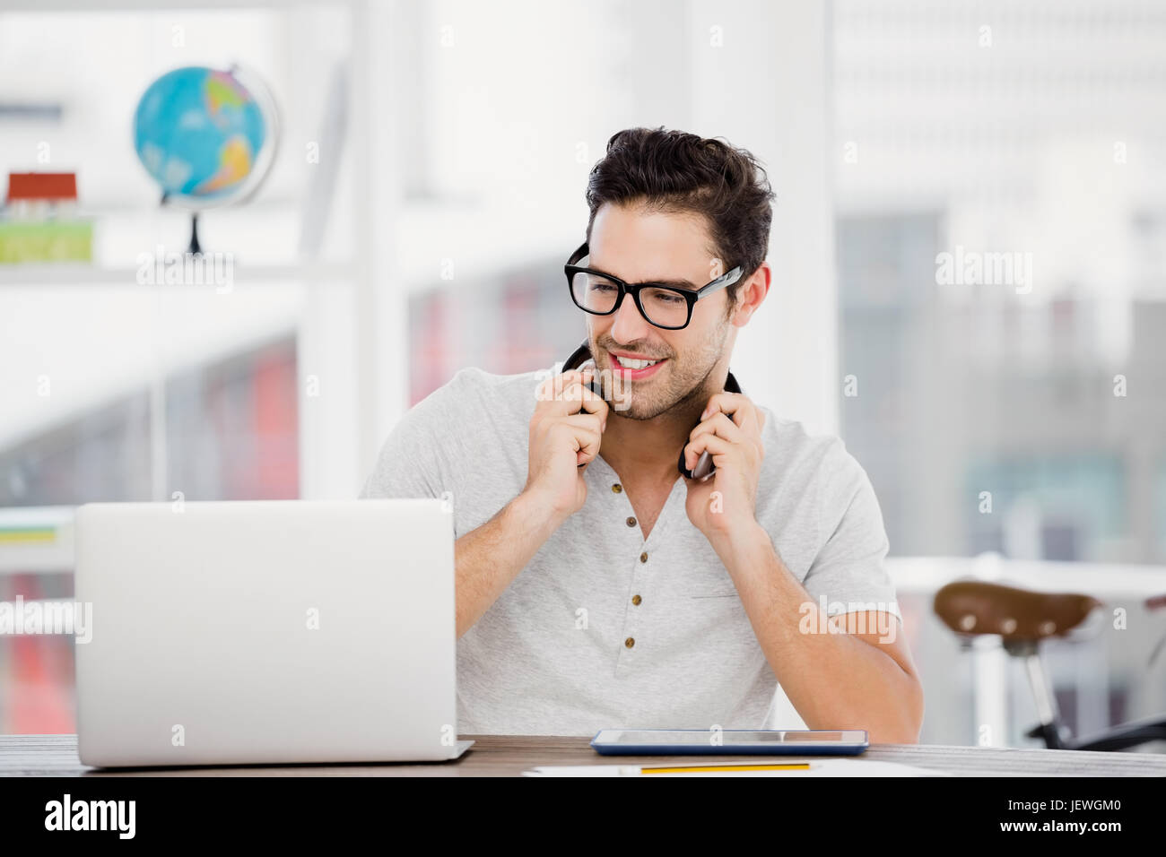 Young man working at his desk Stock Photo - Alamy