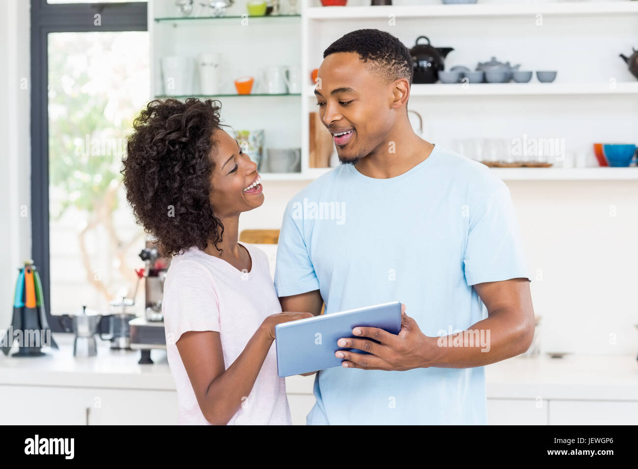 Happy couple using digital tablet Stock Photo - Alamy