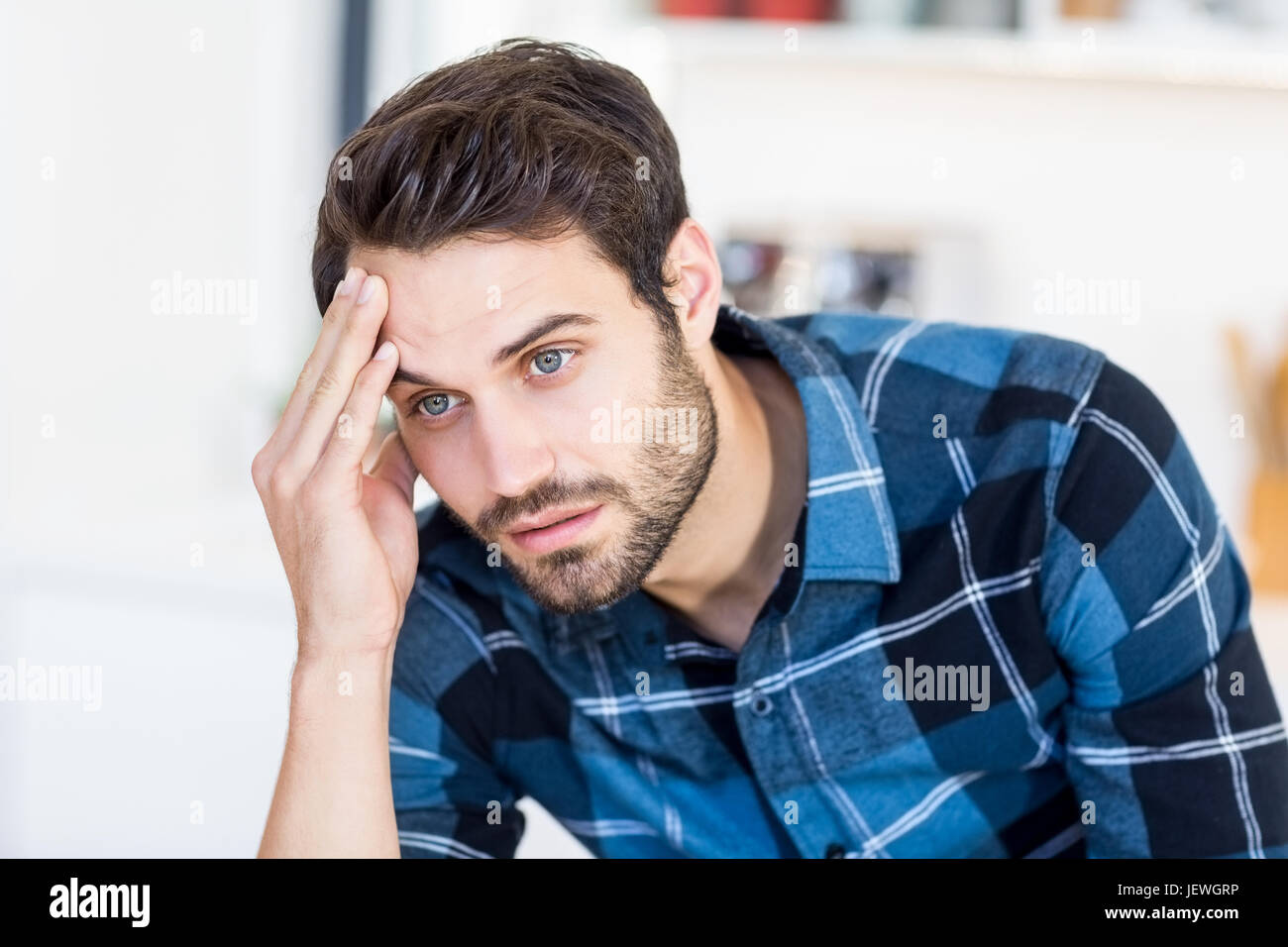 Close-up of tensed young man Stock Photo - Alamy