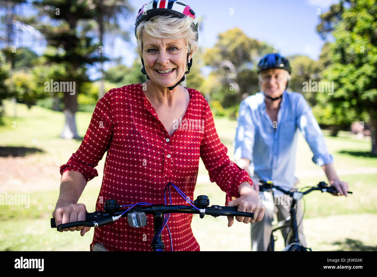Senior woman riding a bicycle Stock Photo - Alamy