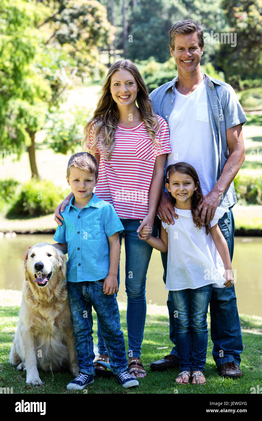 Happy family standing in the park Stock Photo - Alamy