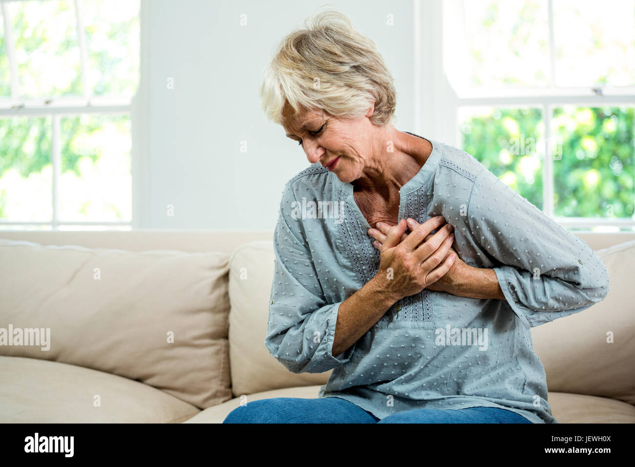 Woman touching her chest hi-res stock photography and images - Alamy