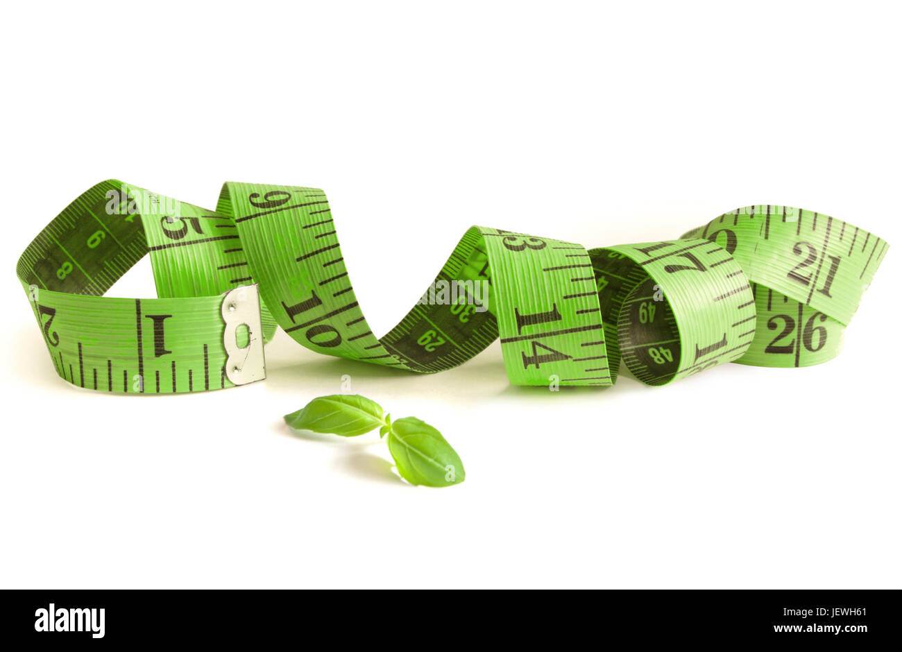 Green measuring tape over a white background with leaf Stock Photo - Alamy