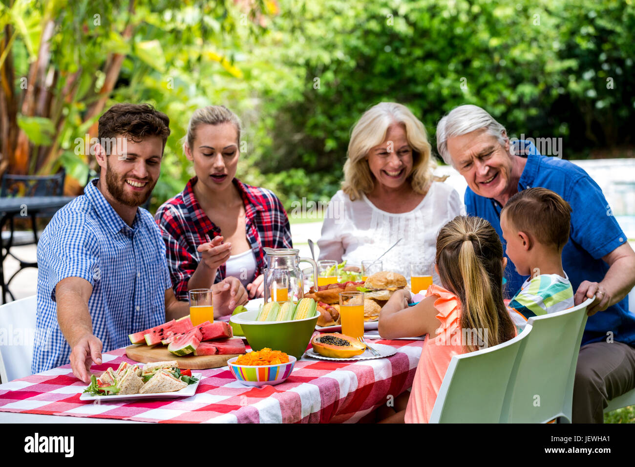 Family having lunch together at lawn Stock Photo - Alamy