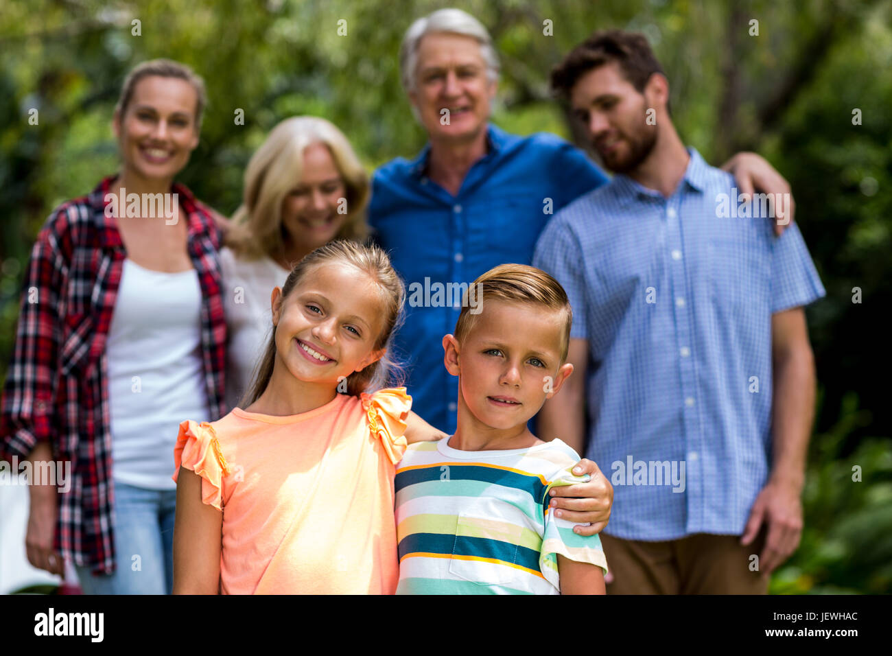 Multi-generation family standing in yard Stock Photo - Alamy